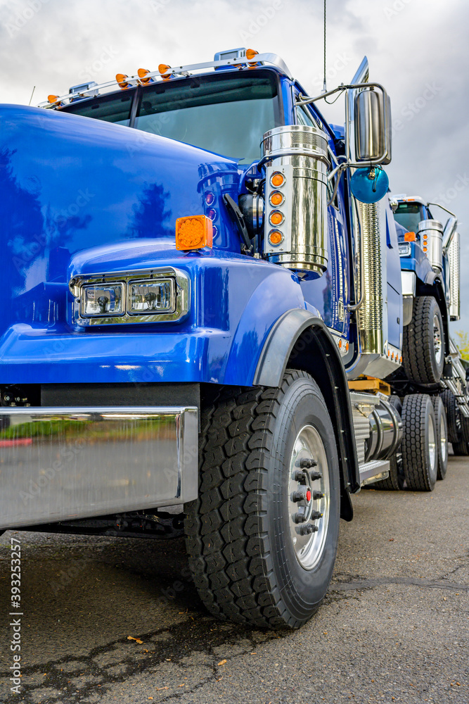 Blue big rig semi truck towing another semi truck tractor on the ...