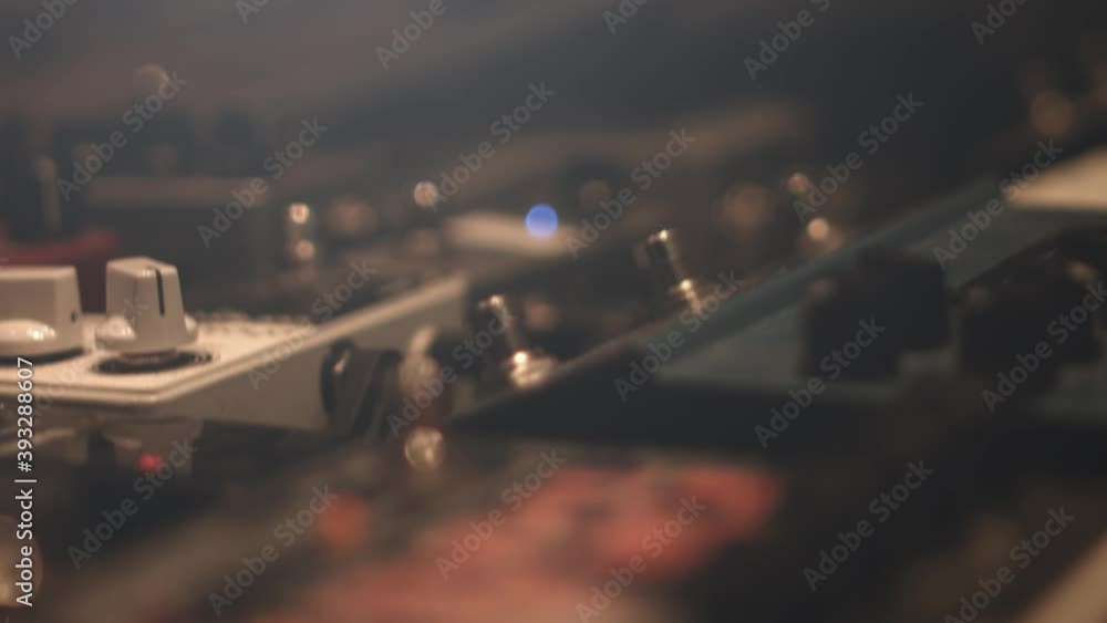 Close up of different guitar pedal effect stomp boxes on the floor in a ...