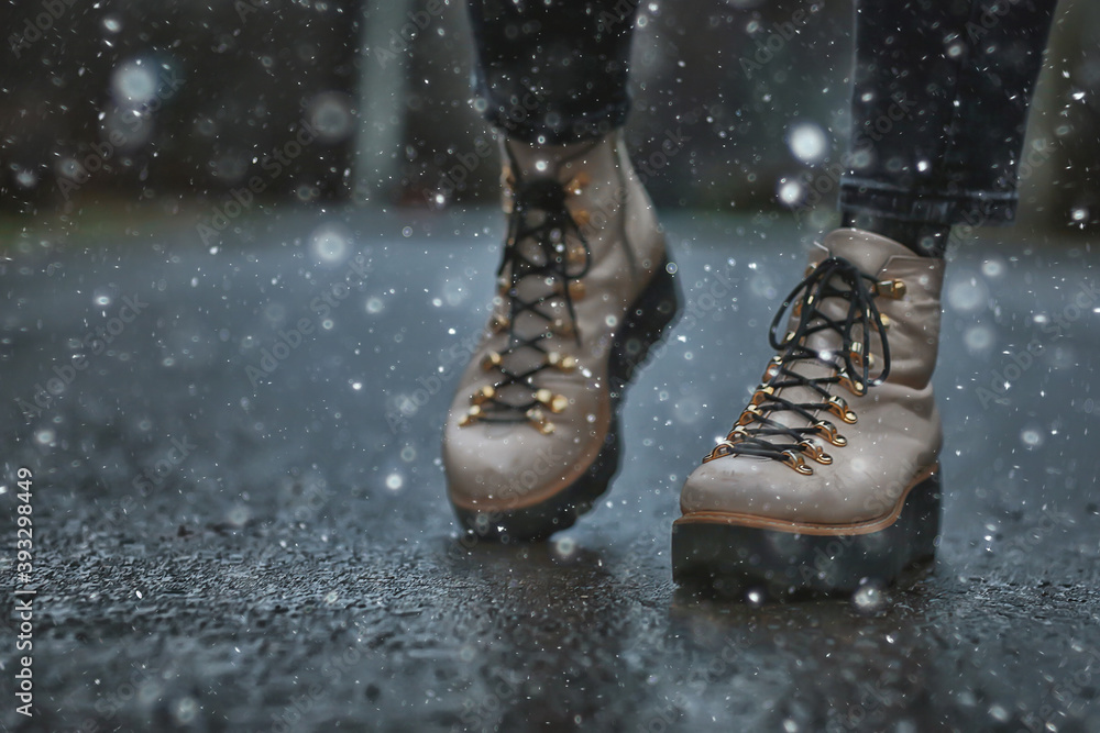 feet in winter boots walk in the park, abstract seasonal background ...