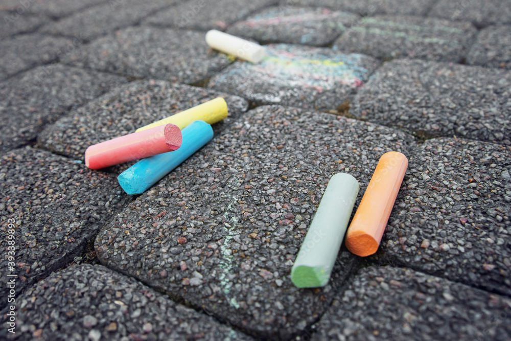 Colored chalk on playground with drawings on street.children drawing on ...