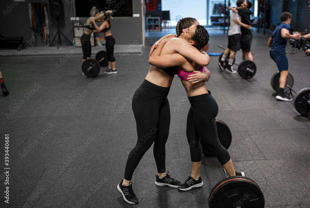 Athletes hugging each other while standing at gym Stock Photo | Adobe Stock