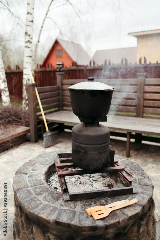 Cooking over an open fire outdoor. Stock Photo | Adobe Stock