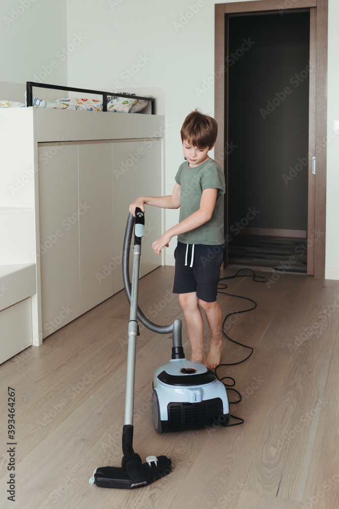 A young boy is cleaning the room. Stock Photo | Adobe Stock