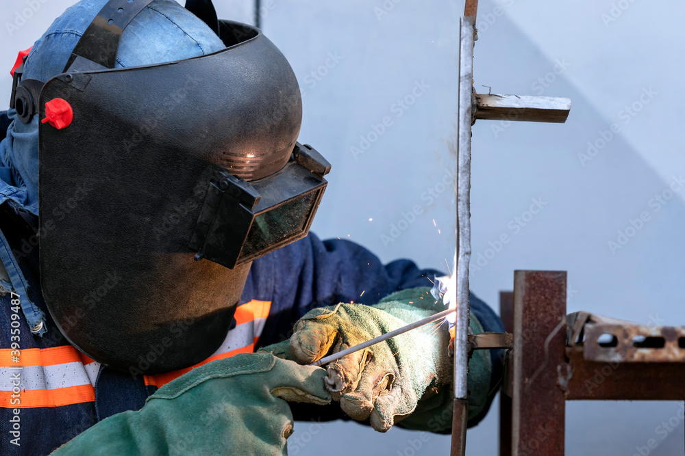 Welder qualification. The welder is welding with shielded metal arc ...