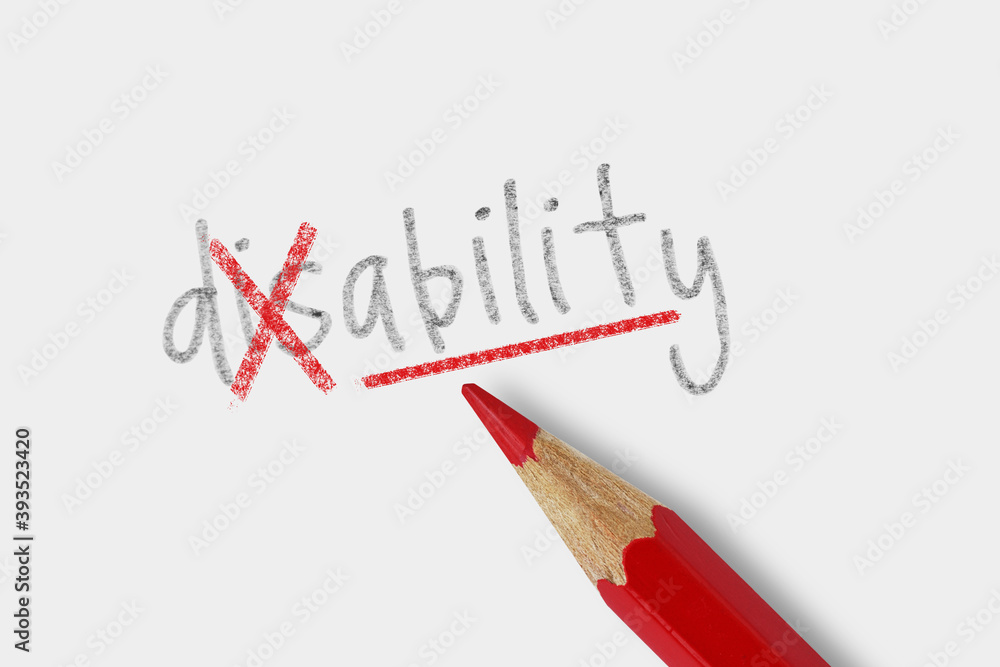 The word disable corrected with red pencil on white background ...