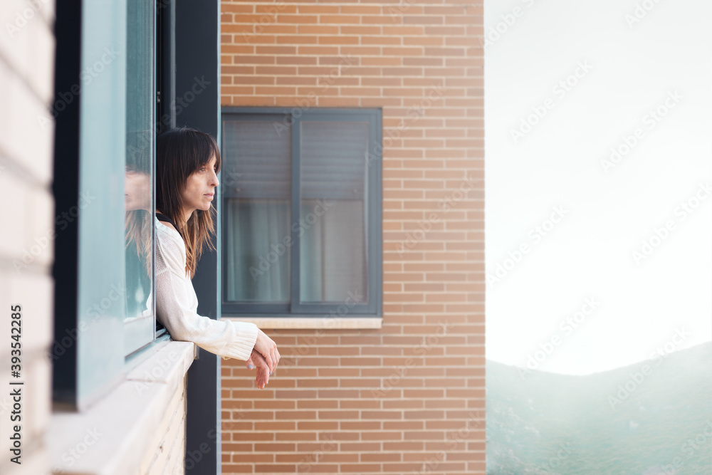 Mujer asomada a la ventana de una casa de campo Stock Photo | Adobe Stock