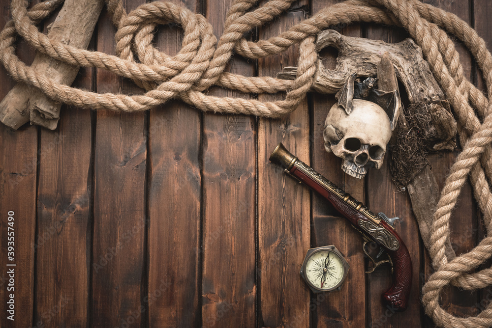 Pirate table concept background with copy space. Human skull, musket ...