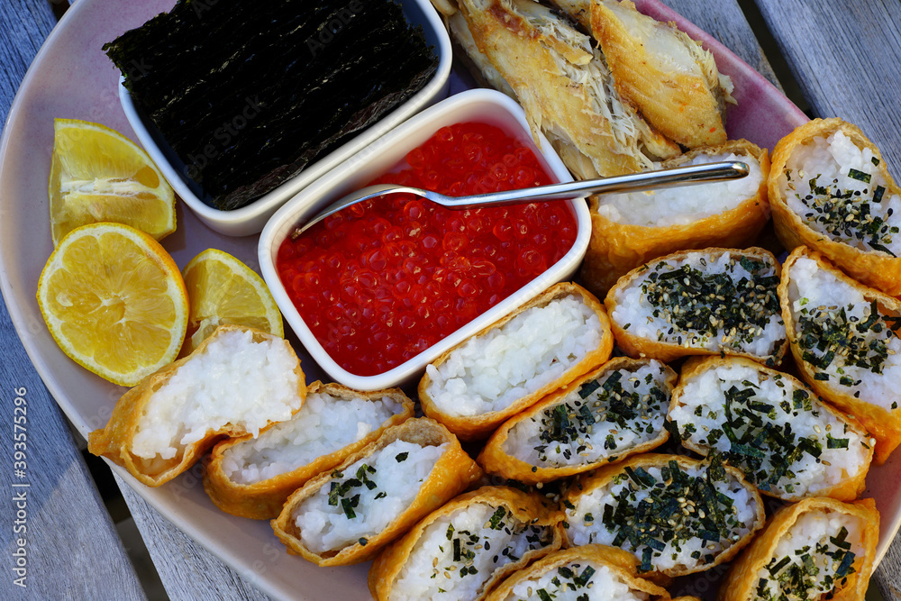 Inari rolls, tofu skins stuffed with sushi rice, with ikura salmon roe ...