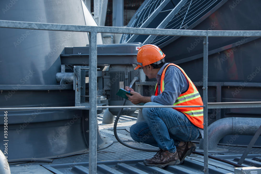 worker open valve of cooling tower on blue sky background. worker ...