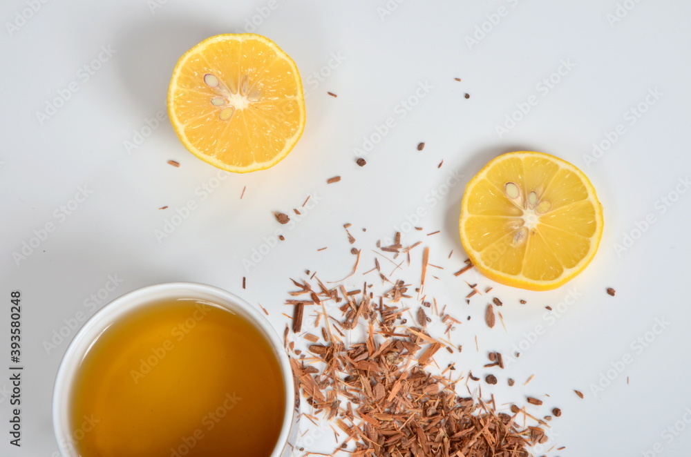 Cup of tea, Catuaba bark and lemon on white background. Natural herbal ...
