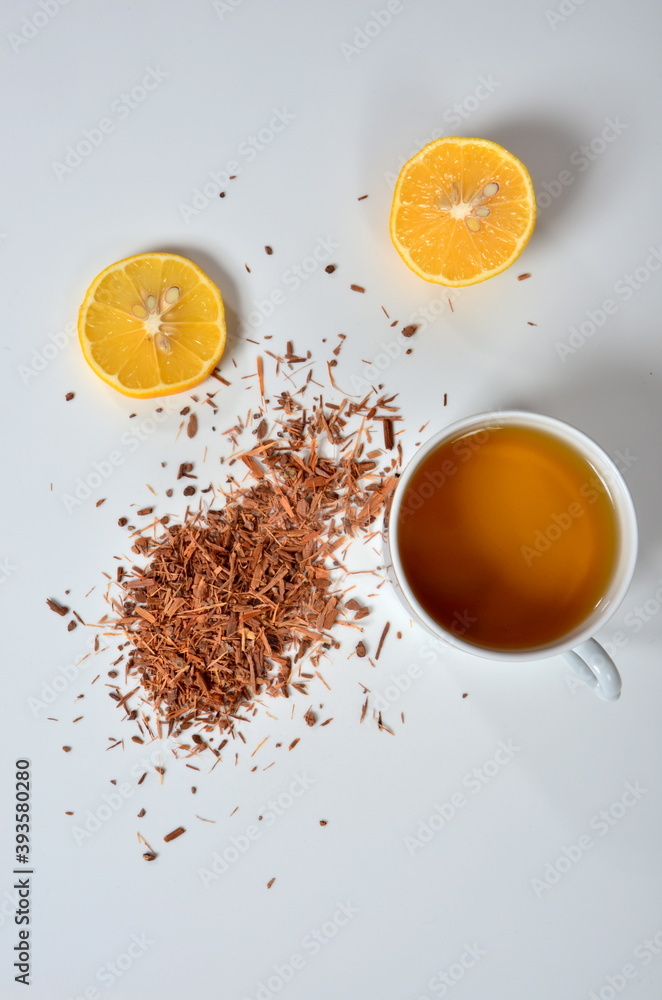 Cup of tea, Catuaba bark and lemon on white background. Natural herbal ...