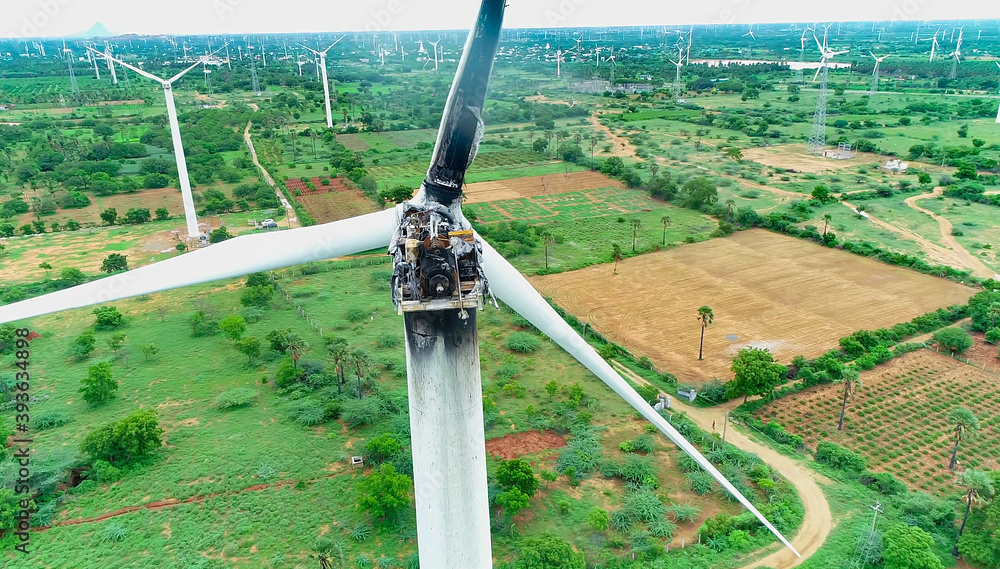 Aerial, close up view of wind turbine power plant Burned damaged wind ...