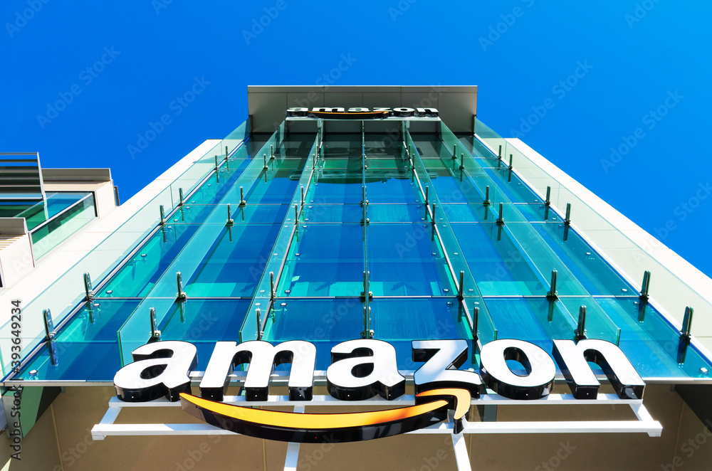 Amazon logo with its signature orange smile on the glass facade of ...