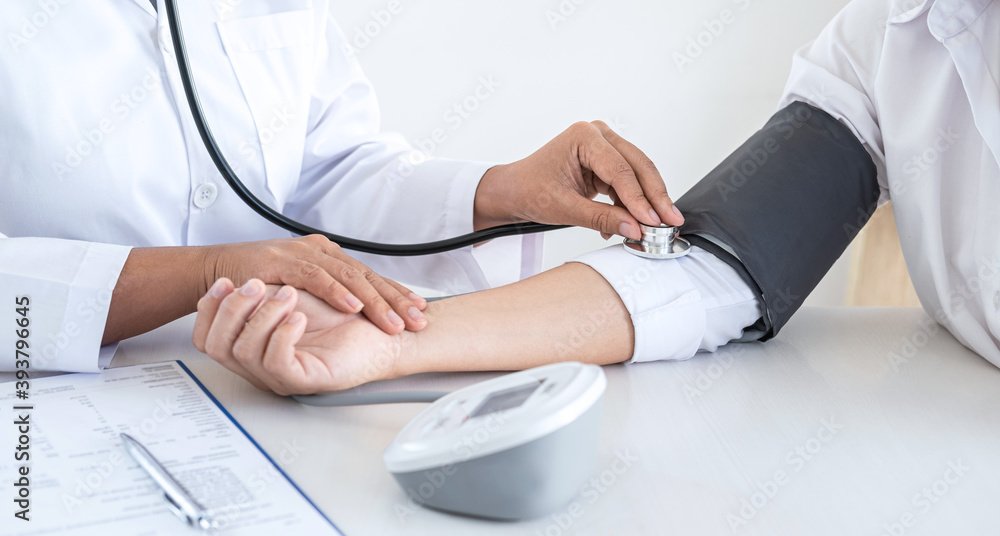 Doctor using a measuring blood pressure checking patient with examining ...