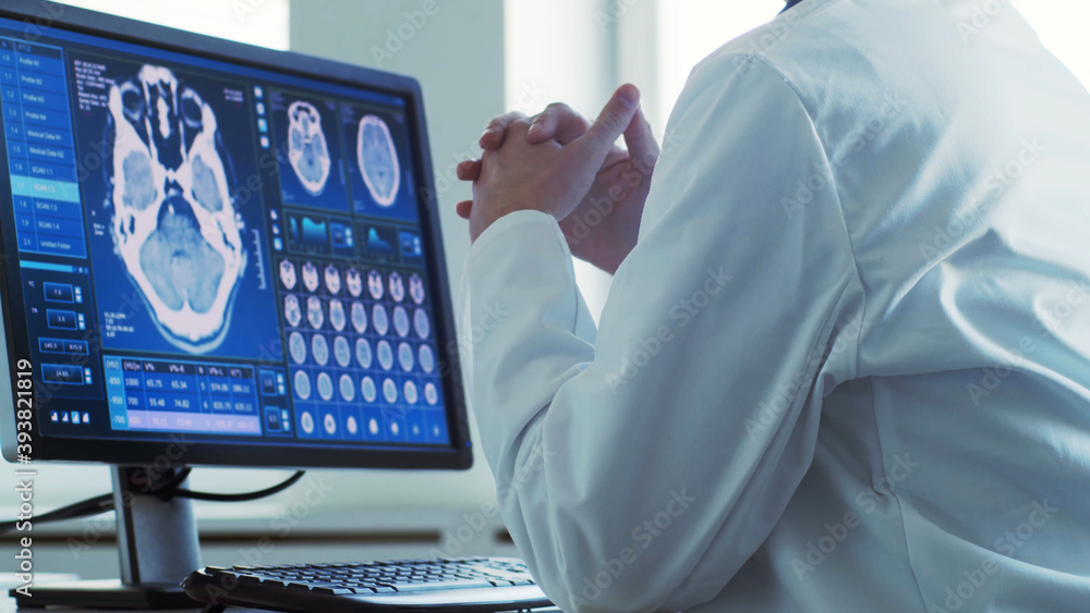 Professional medical doctor working in hospital office using computer ...