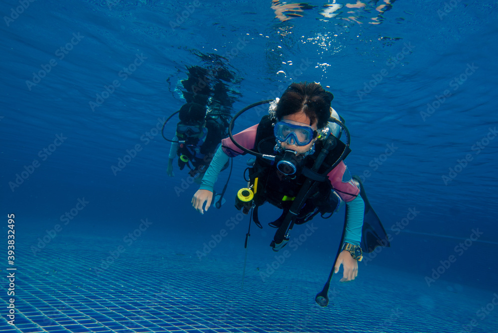 Underwater, a 10 year old boy diving in a pool with fun. This is diving ...