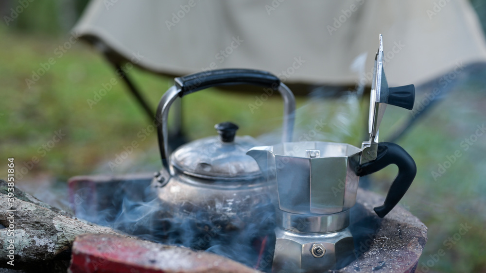 Moka pot local coffee style and kettle in the wood stove on camping ...