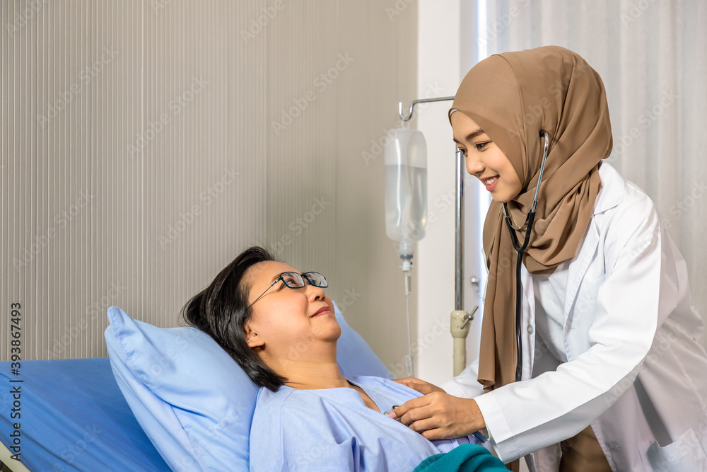 Muslim female woman medical doctor using stethoscope to listen to ...