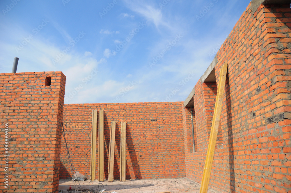 An inside view from an incomplete brick house construction with built ...