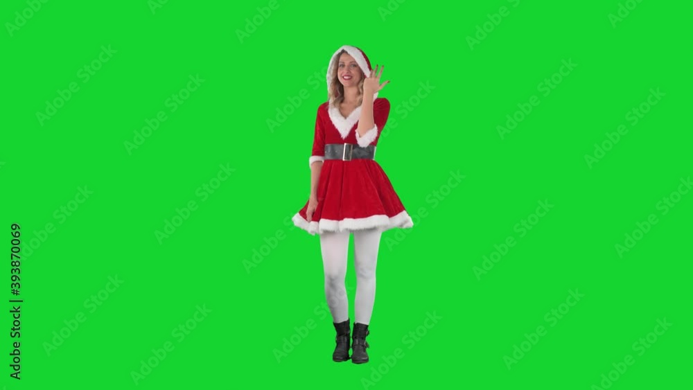 Happy Santa Claus girl counting up from one to ten looking at camera ...