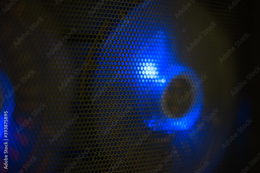 Blue led lighting PC computer cooling fans behind black wire mesh close ...