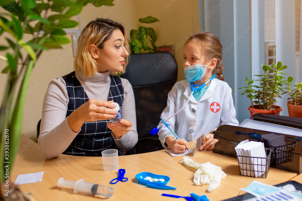 Little girl playing pretends like paediatrician doctor examining a ...
