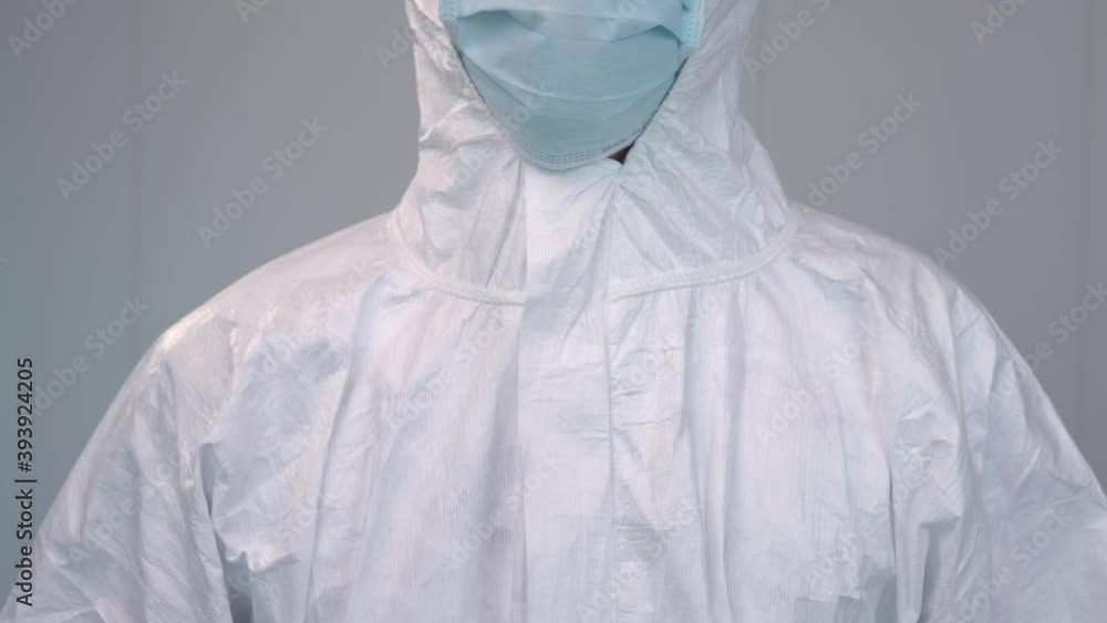 A nurse prepares by putting on protective suit during coronavirus ...
