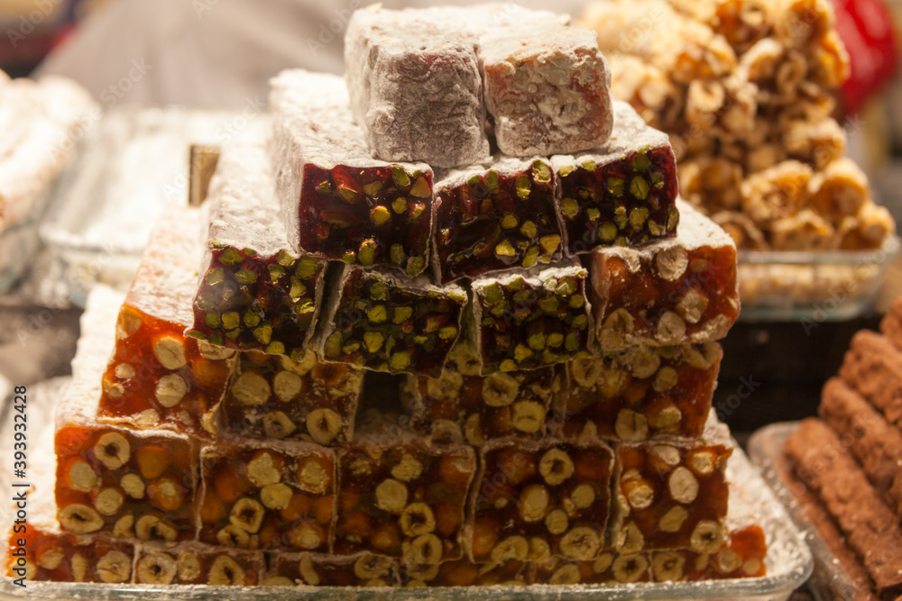 Turkish delight with pistachio nuts and hazelnuts. They are next to ...