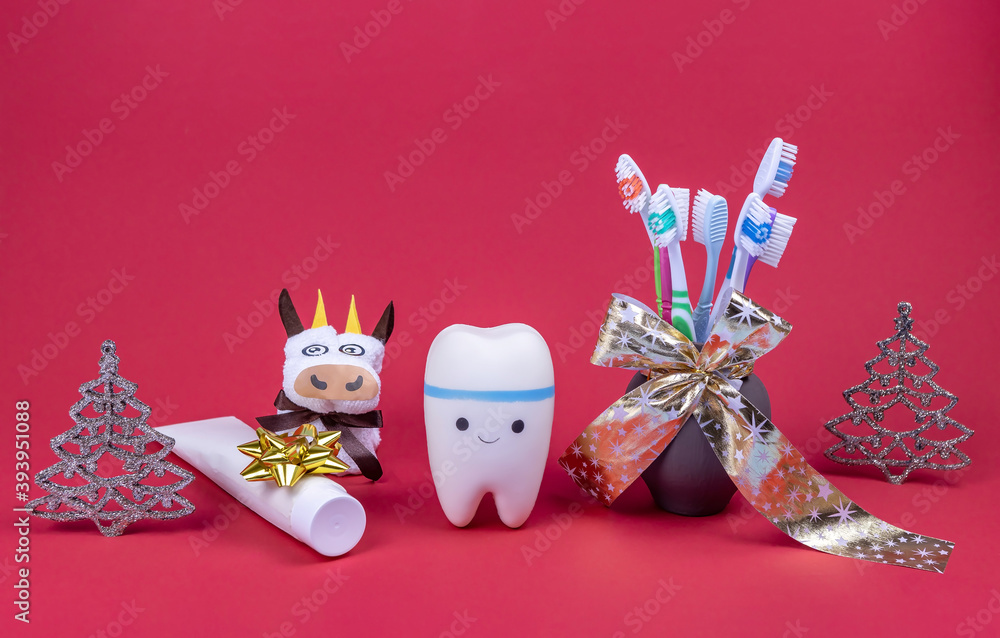 toy dental model, toothbrushes in a vase with a gift ribbon, symbol of ...