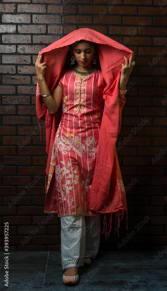 Indian girl with makeup and a fashionable hairstyle poses in Indian ...