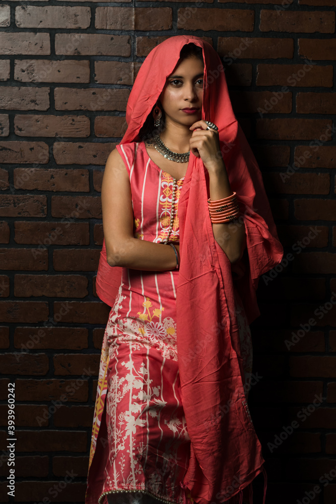 Indian girl with makeup and a fashionable hairstyle poses in Indian ...