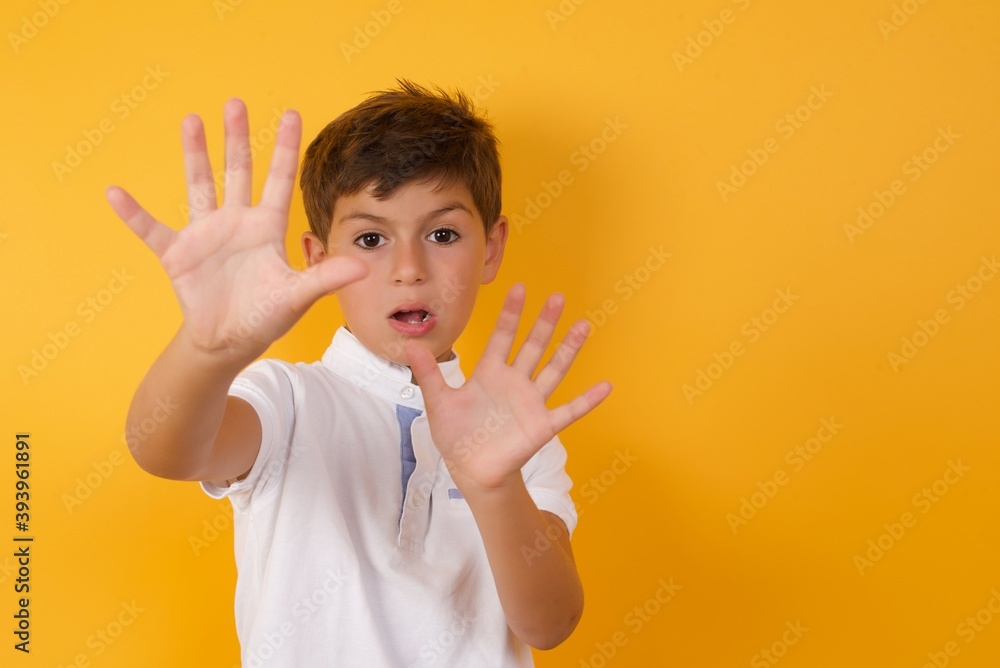Dissatisfied little cute Caucasian boy kid wearing white t-shirt ...