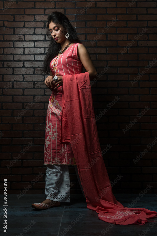 Indian girl with makeup and a fashionable hairstyle poses in Indian ...