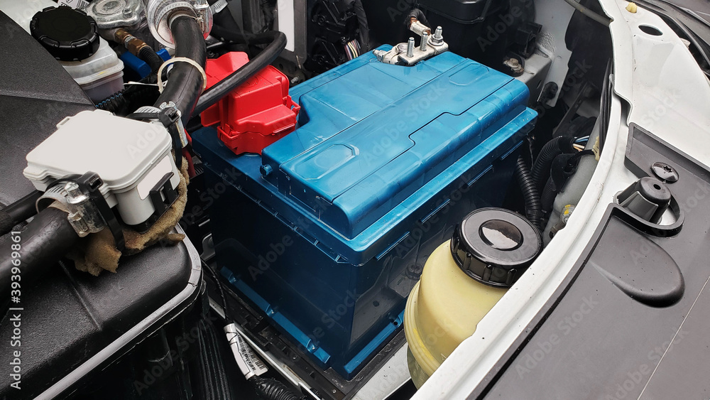 Blue car battery installed and connected in car. Electricity and energy ...