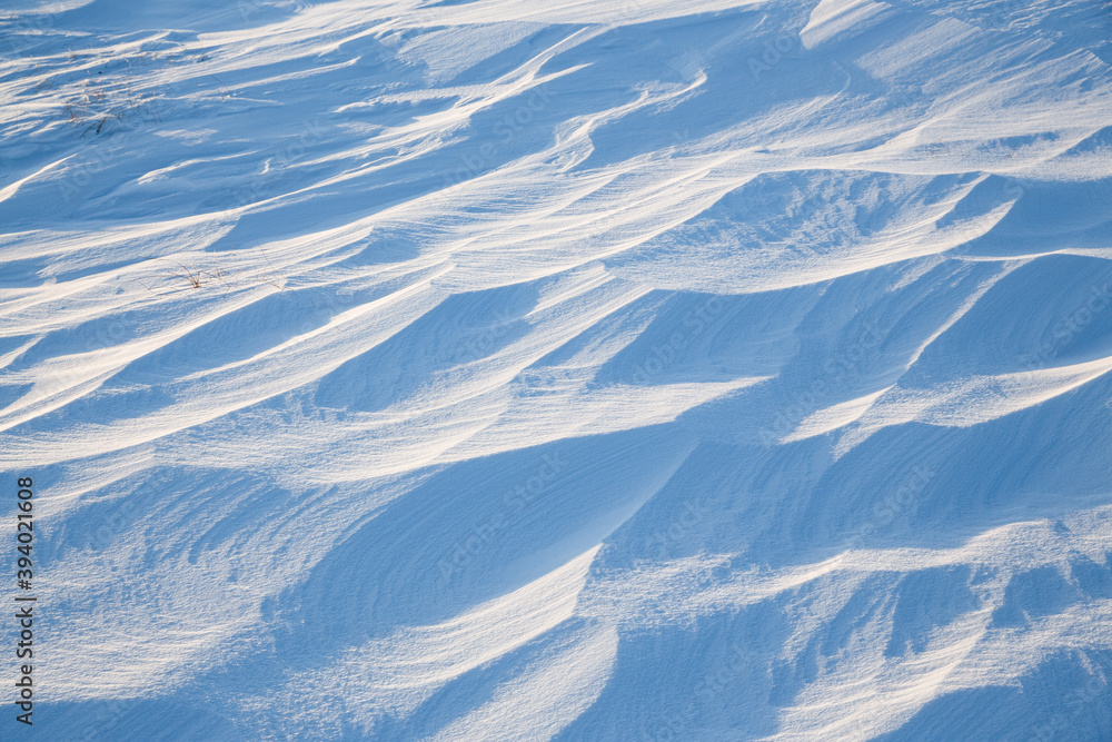 Snow texture. Wind sculpted patterns on snow surface. Wind in the ...