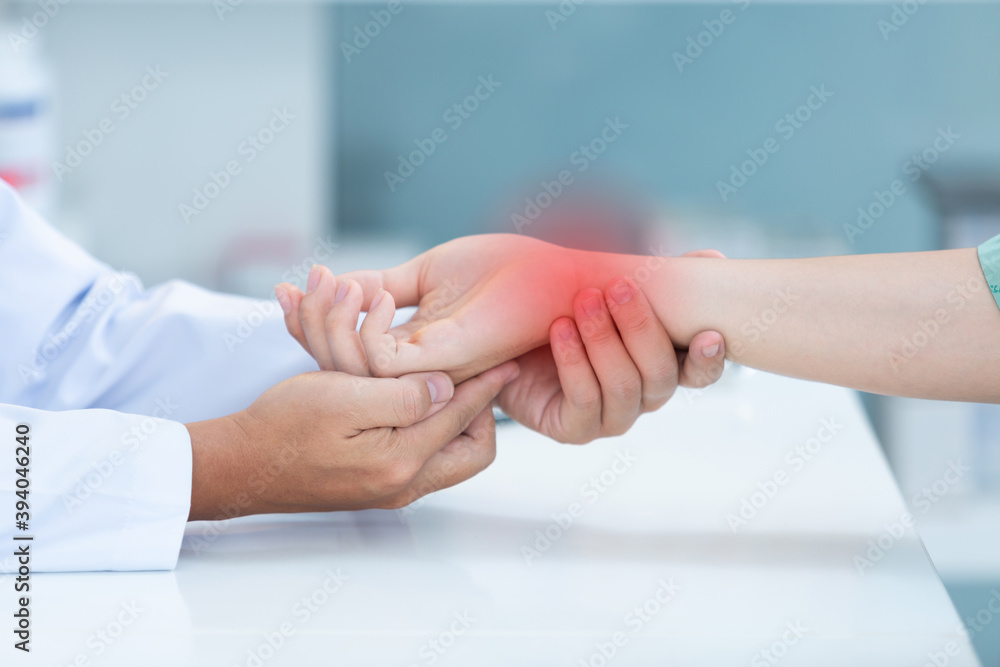 Close up doctor examining patient with wrist bone problems painful ...