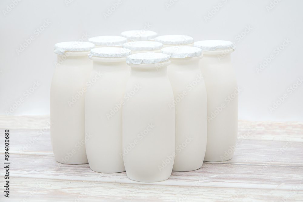 Natural liquid yogurt with probiotics in small plastic bottles on ...