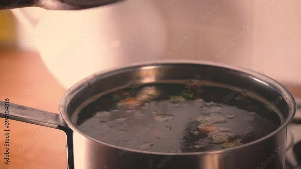 Make dinner. Minestrone soup boiling in the pot, woman cooking ...