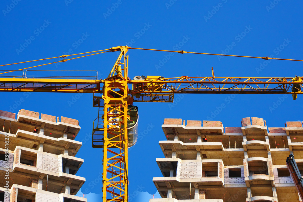 Crane near buildings. Construction site background. Industrial ...
