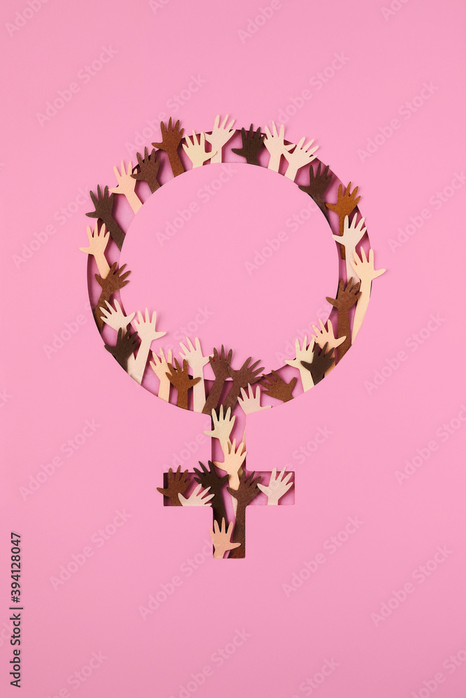 Female biological symbol cut from paper sheet and filled with hands in ...