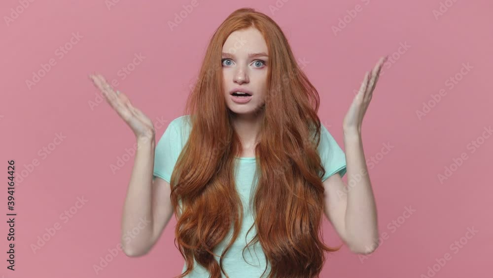 Angry irritated shocked redhead young woman in casual blue turquoise t ...