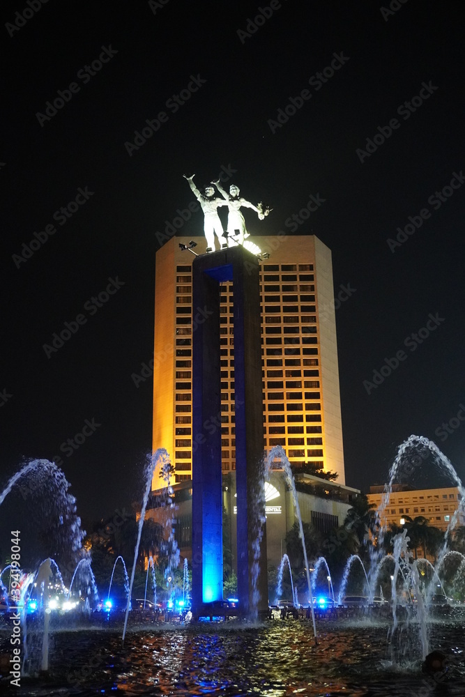 Colorful fountain show at iconic statue of Patung Selamat Datang at ...