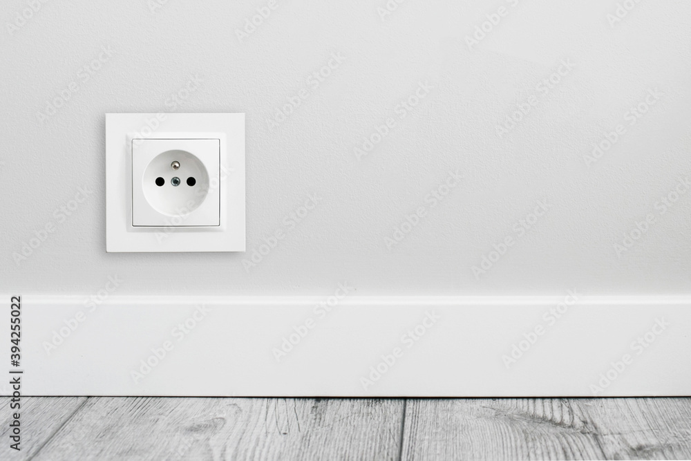 Electrical socket isolated on gray wall. Renovated studio apartment ...