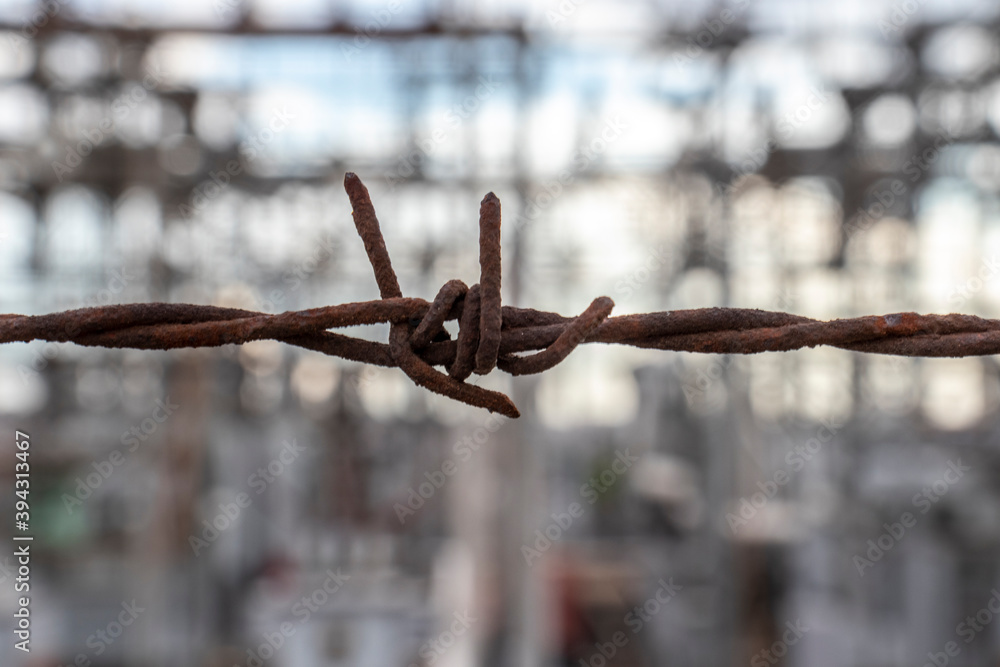 rusty barbed wire from a security fence of an electrical power ...
