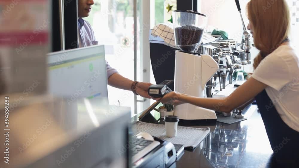 customer paying credit card at cafe store. young asian smiling barista ...