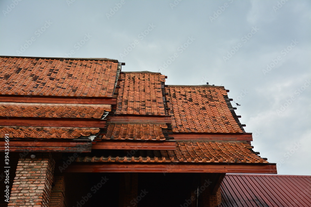The gable roof uses clay tile materials. Stock Photo | Adobe Stock