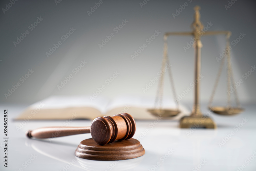 Law and justice concept. Gavel, legal code and scale on the off-white ...