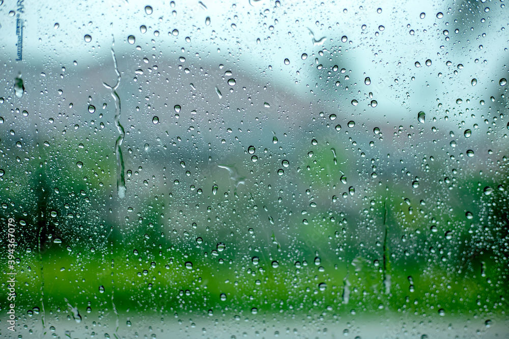 The background of rainwater drops on the glass, the waterless wallpaper ...