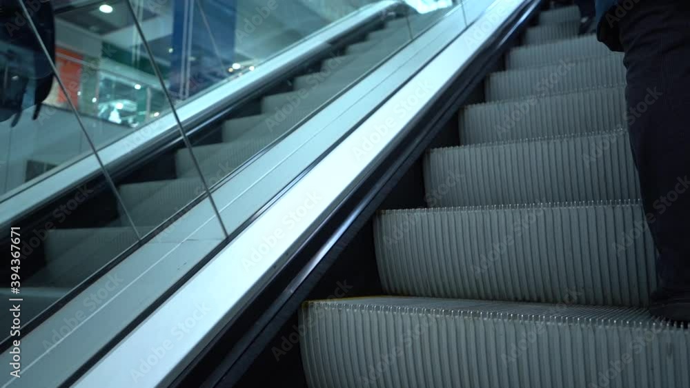 Go up the escalator. Close-up. Modern escalator stairs move up and down ...