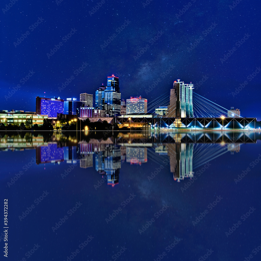 A skyline view of Kansas City over the Missouri River with reflections ...